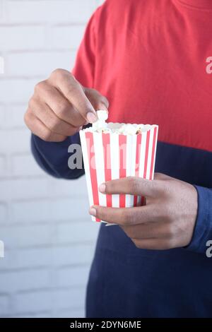 young man eating popcorn close up Stock Photo - Alamy