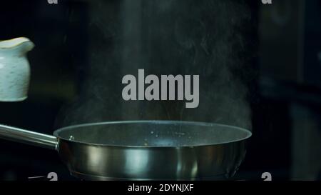Chef pouring water into bowl Stock Photo - Alamy