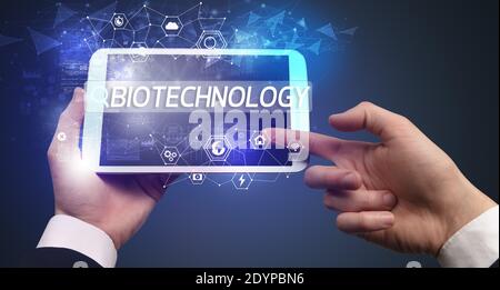 Close-up of a tablet searching BIOTECHNOLOGY inscription, hi-tech ...