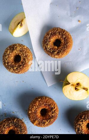 Sheet of baking paper with tasty donuts on dark background, closeup ...