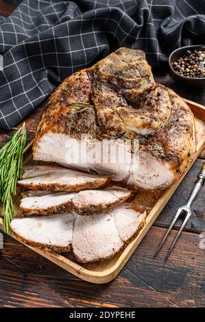 Baked sliced pork leg knuckle. Dark wooden background. Top view Stock ...