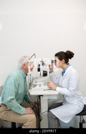 Ophthalmologist is checking up patient in eye doctor hospital Stock ...