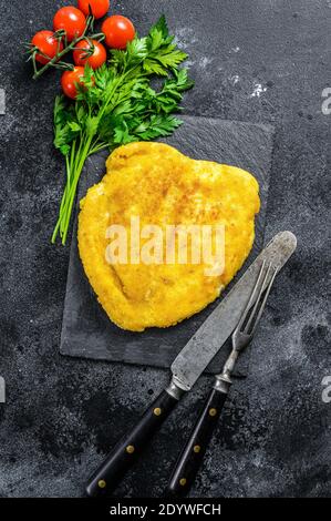 Traditional fried chicken schnitzel. Black background. Top view Stock ...