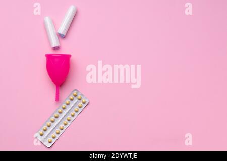 Menstrual cup and oral contraceptive pills top view Stock Photo - Alamy