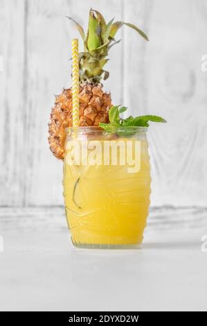Glass of pineapple tiki style cocktail on white background Stock Photo ...