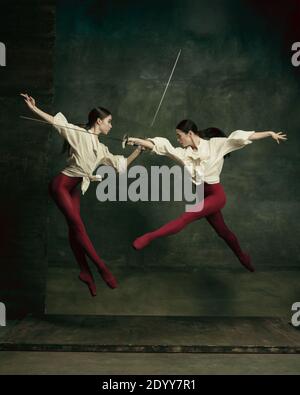 Fatal. Two young female ballet dancers like duelists with swords on ...