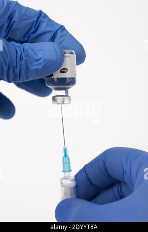 Brnenec, Czech Republic - December 12, 2020: Fingers in gloves, syringe ...