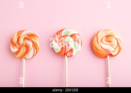 Three lollipop candies on pink pastel background. copy space, top view ...