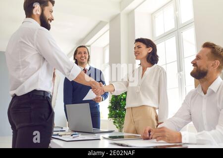 handshake Manager and customer in a modern office Stock Photo - Alamy