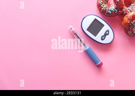 diabetic measurement tools, insulin and donuts on pink Stock Photo - Alamy