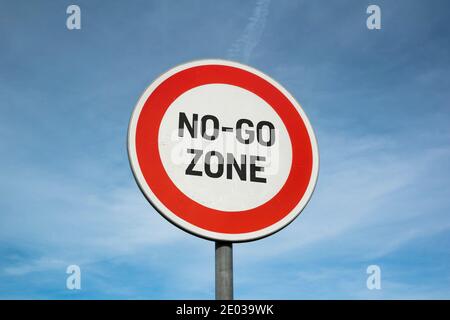 “No-Go Zone” warning sign over grungy white and red old rusty road ...