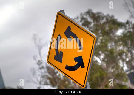 A Yellow Traffic Sign With Three Arrows Going In A Circle; Calgary, Alberta, Canada Stock Photo ...