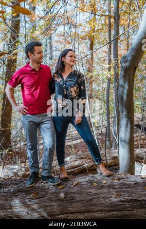 Beautiful middle age couple together standing over isolated yellow ...