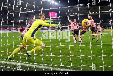 Burnley's Ben Mee scores their side's first goal of the game to level ...