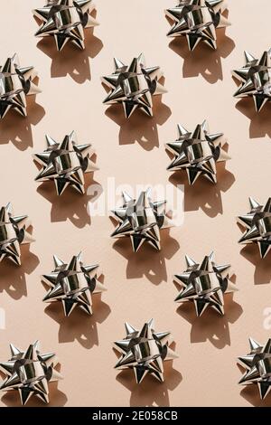 silver ribbon bows on pink background. festive template for christmas ...