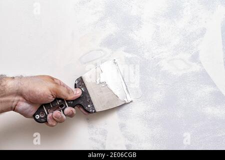 the process of leveling the wall before painting. repairs. copy space ...