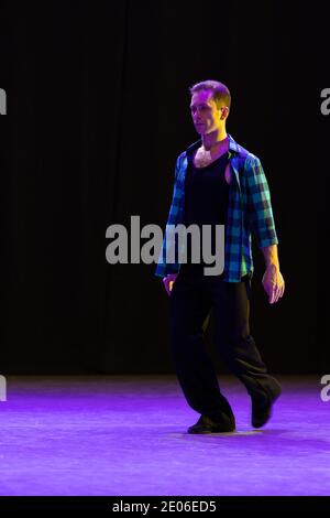 Actor dancer young man performs in the theater on stage in a dance ...