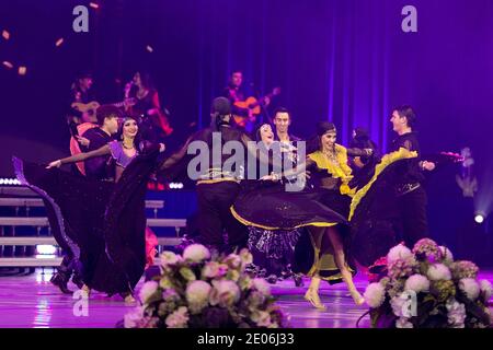 A team of musicians and singers perform on stage in front of the ...