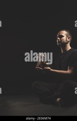 Young man with Tibetan singing bowl at home Stock Photo - Alamy