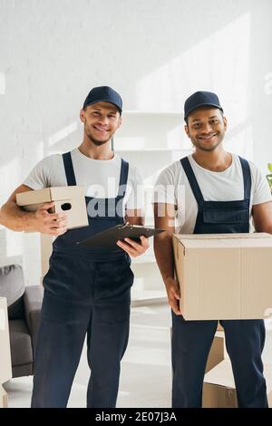 happy handymen in caps looking at camera, banner Stock Photo - Alamy