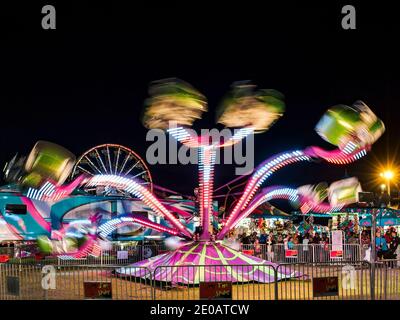 Spinning rides are colorful at the county fair Stock Photo - Alamy