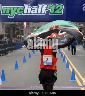 Peter Kirui of Kenya crosses the finish line and won the New York City ...