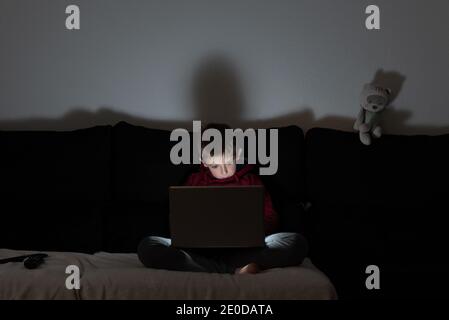 Preteen kid using laptop during online education near copy books and ...