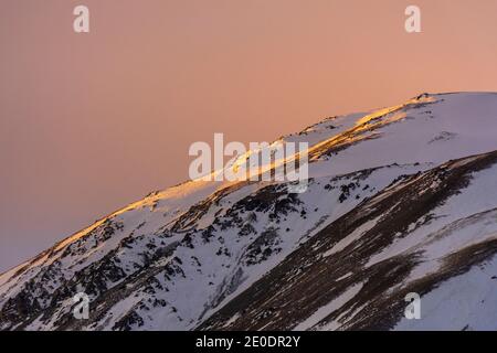 Alpenglow over snow-capped Andes mountains during sunset in Esquel ...