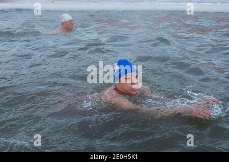 Winter swimming enthusiasts swim in the icy water in Harbin City ...