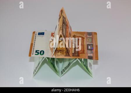 A tiny building made of different Euro banknotes Stock Photo - Alamy