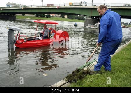 A rubbish collecting barge floating on the river thames London, rubbish ...