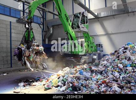Waste sorting and recycling plant. Loader and grab crane are handling ...