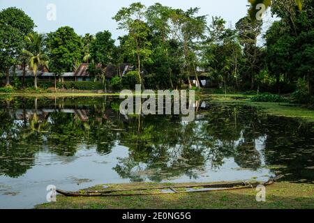 India, Assam, Majuli Island, tourism, bamboo cottage bungalow resort tourist walking to thatched ...