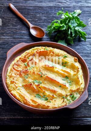 baked mashed potatoes with parmesan cheese and butter in a baking dish ...