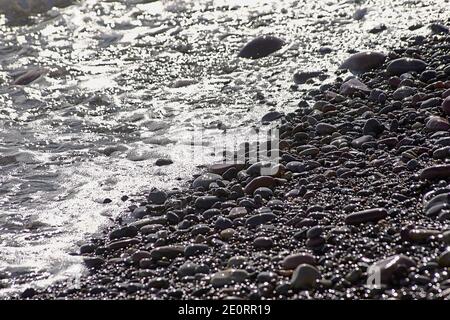 Small rocks beach shore, unfocused background, nobody, foreground ...