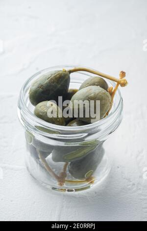 Capers, marinated in oil, on white background, flat lay Stock Photo - Alamy