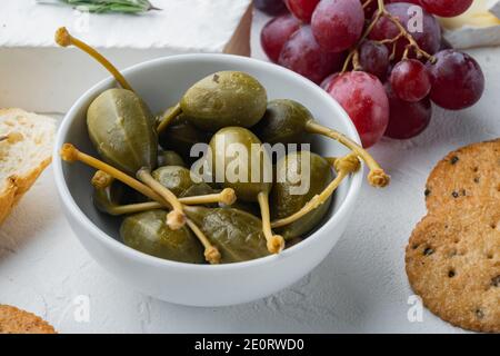 Capers, marinated in oil, on white background, flat lay Stock Photo - Alamy