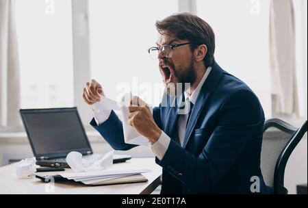 Impulsive man with white sheets of paper in hands emotions office ...