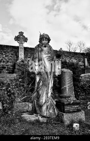Defaced and damaged statue of Jesus in a cemetery Stock Photo - Alamy