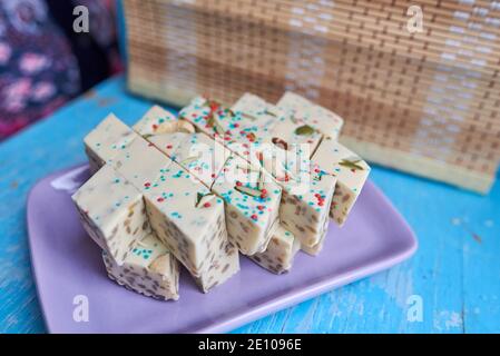 Samarkand halva cut into rhombuses with pistachios and cashews and blue ...