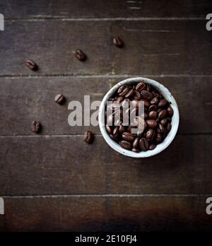 Coffee beans in a small ceramic dish. Close up Stock Photo - Alamy