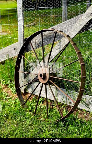 Old-fashioned wagon wheel with steel rim and wire spokes, isolated ...