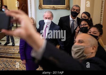 Sen. Cory Booker, D-N.J., takes a selfie with a guest during a ...