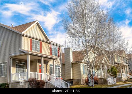 Porch overlooking yard road homes lake and mountain under cloudy blue ...