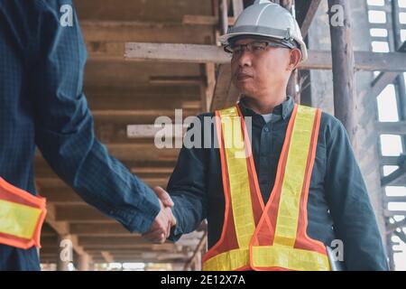 Shake hand concept, two engineer shake hand on site construction to ...