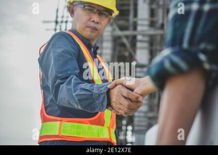Shake hand concept, two engineer shake hand on site construction to ...