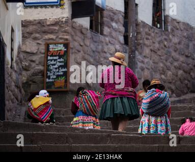 Indigenous Quechua family in local costume inf front of Santo Domingo ...