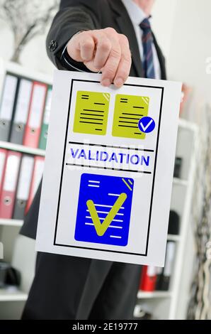 Paper showing validation concept held by a businessman Stock Photo - Alamy