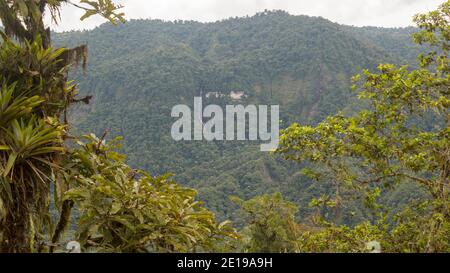 Steep cliff with waterfall and limestone outcrop in the Quijos Valley ...