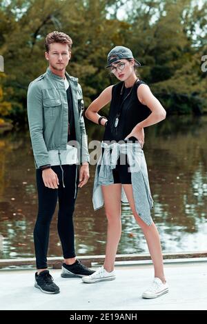 young interracial couple in stylish autumnal outfits posing isolated on ...
